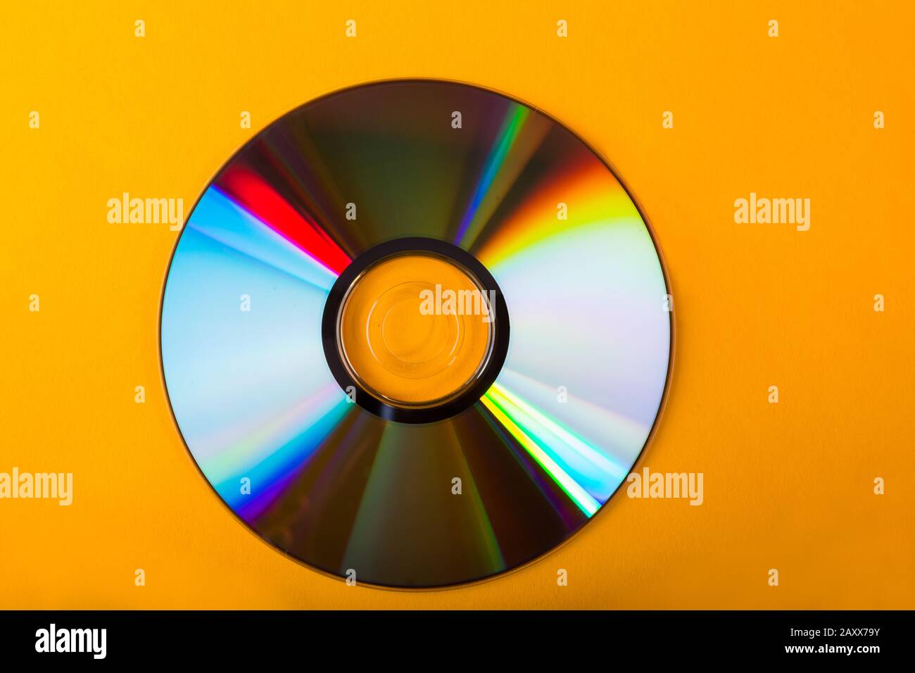 CD isolated in yellow background Stock Photo - Alamy