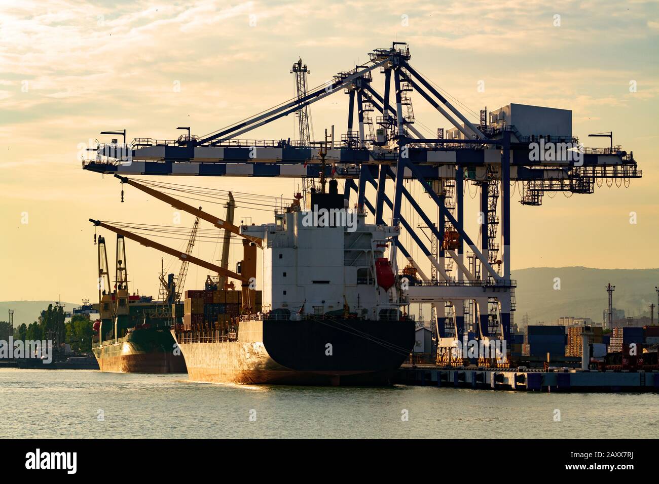 Container ship in a port, evening light Stock Photo - Alamy