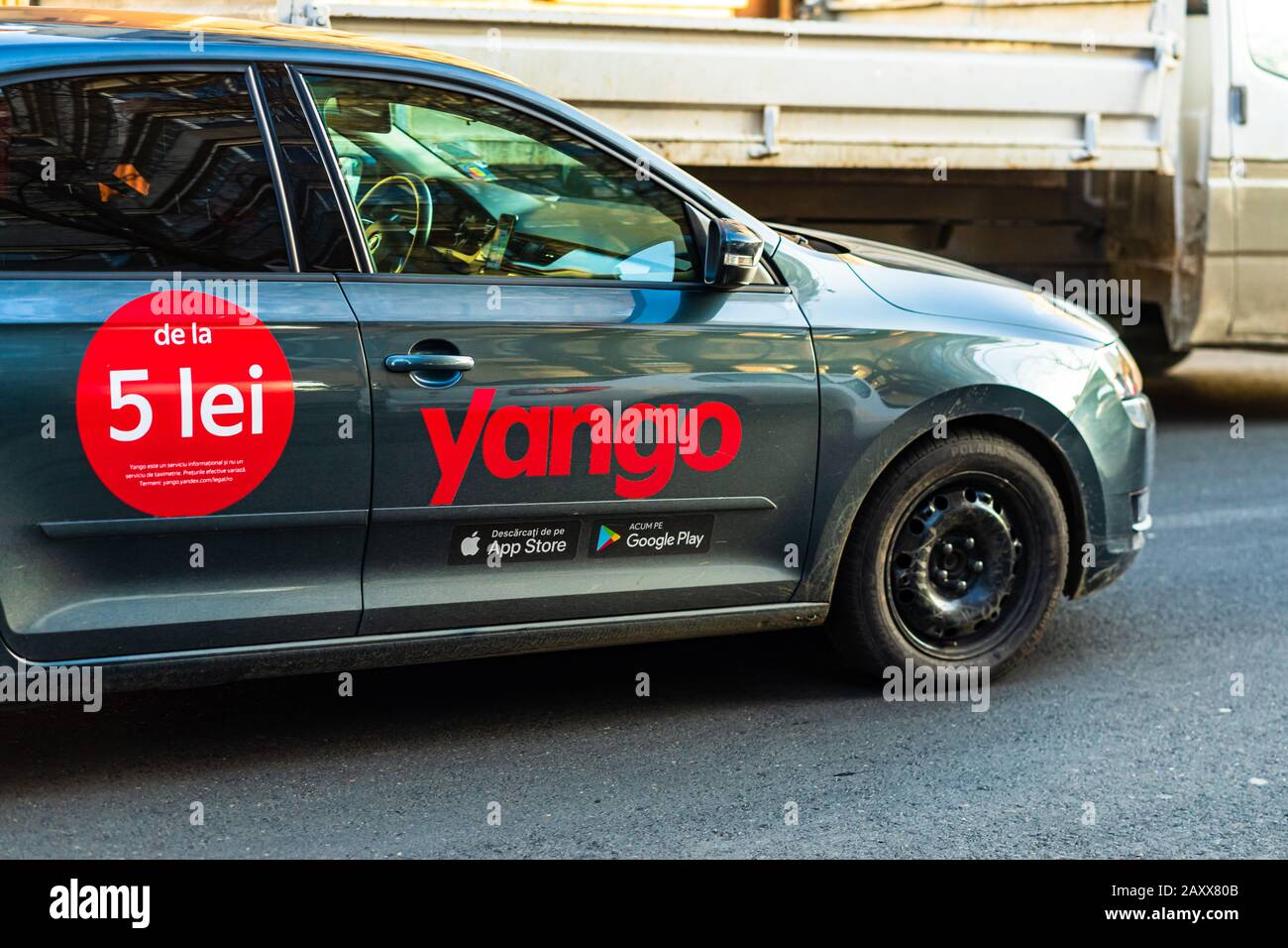 Yango car in traffic at rush hour stopped at red light. Car pollution ...
