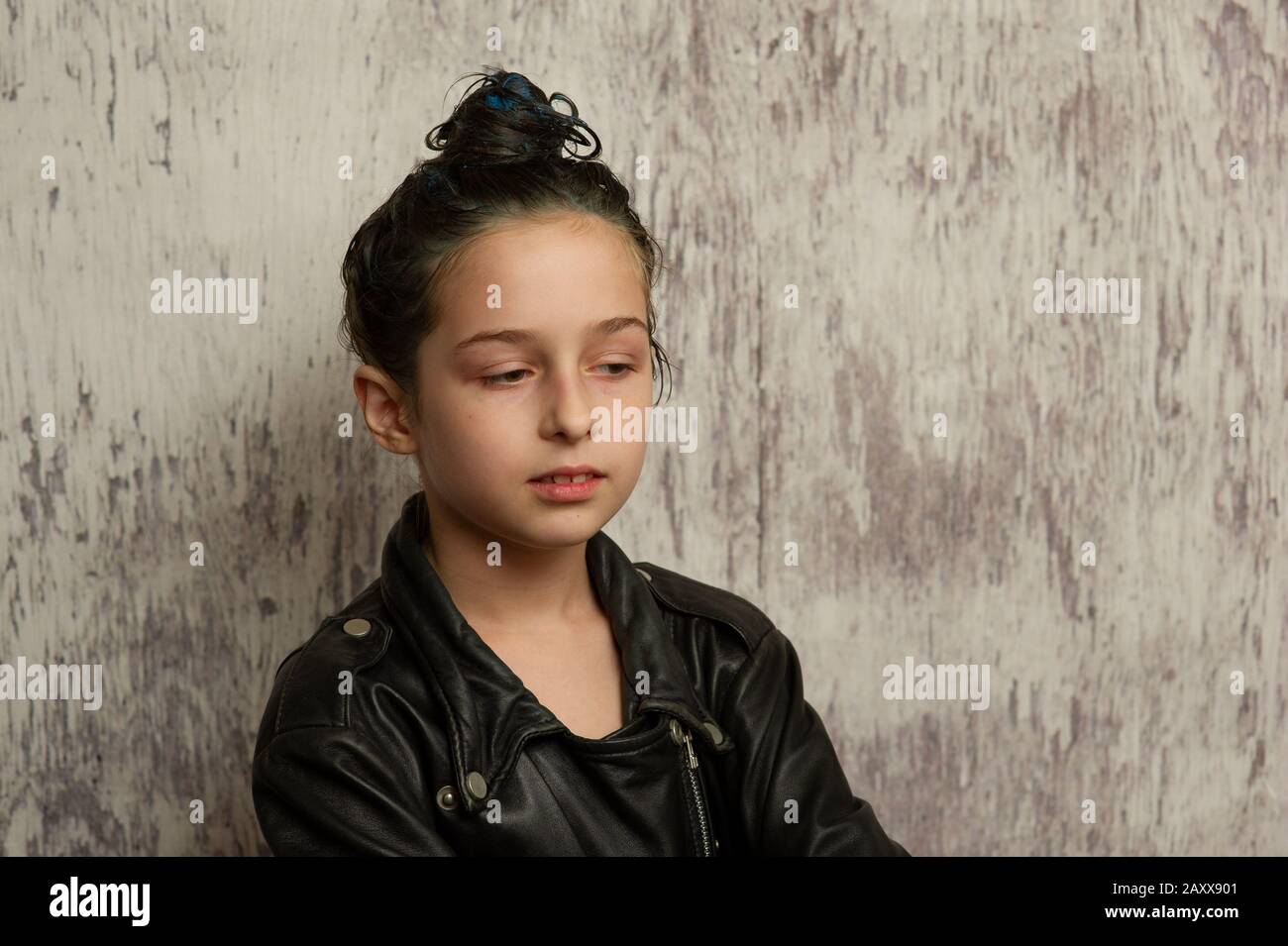 Portrait of nine year old girl. Teenager with blue strands on her hair ...