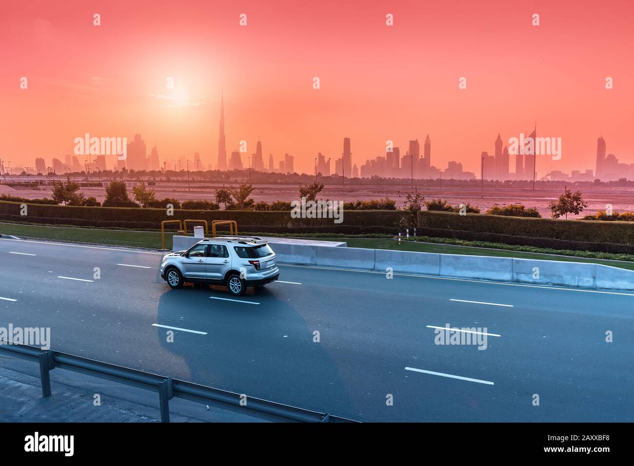 Highway Road and Dubai cityscape skyline at sunset. Transportation and ...