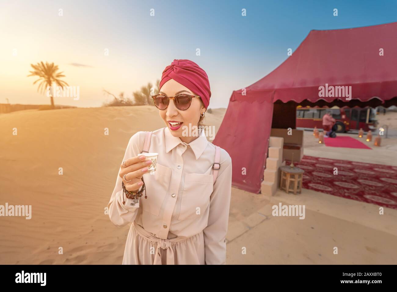 Muslim Woman with turban tasting arabian coffee while having tour and ...