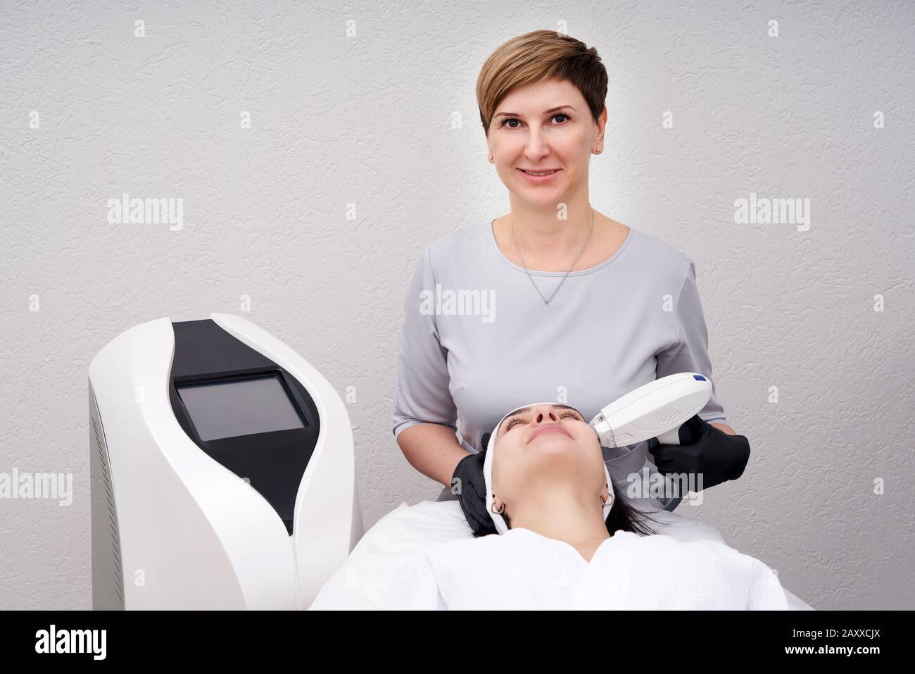 Young woman receiving laser treatment Stock Photo - Alamy