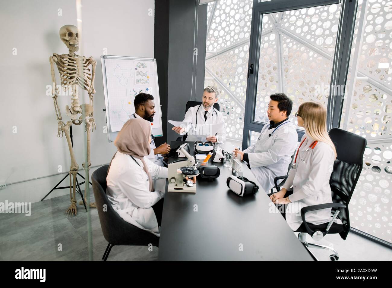 Handsome middle aged man teacher supervisor having class with ...