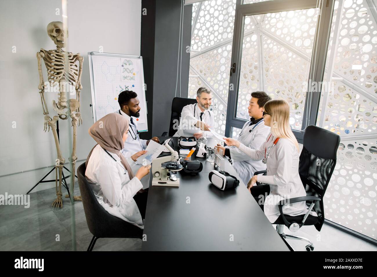 Multi ethnic group of medical students or young reseachers having a ...