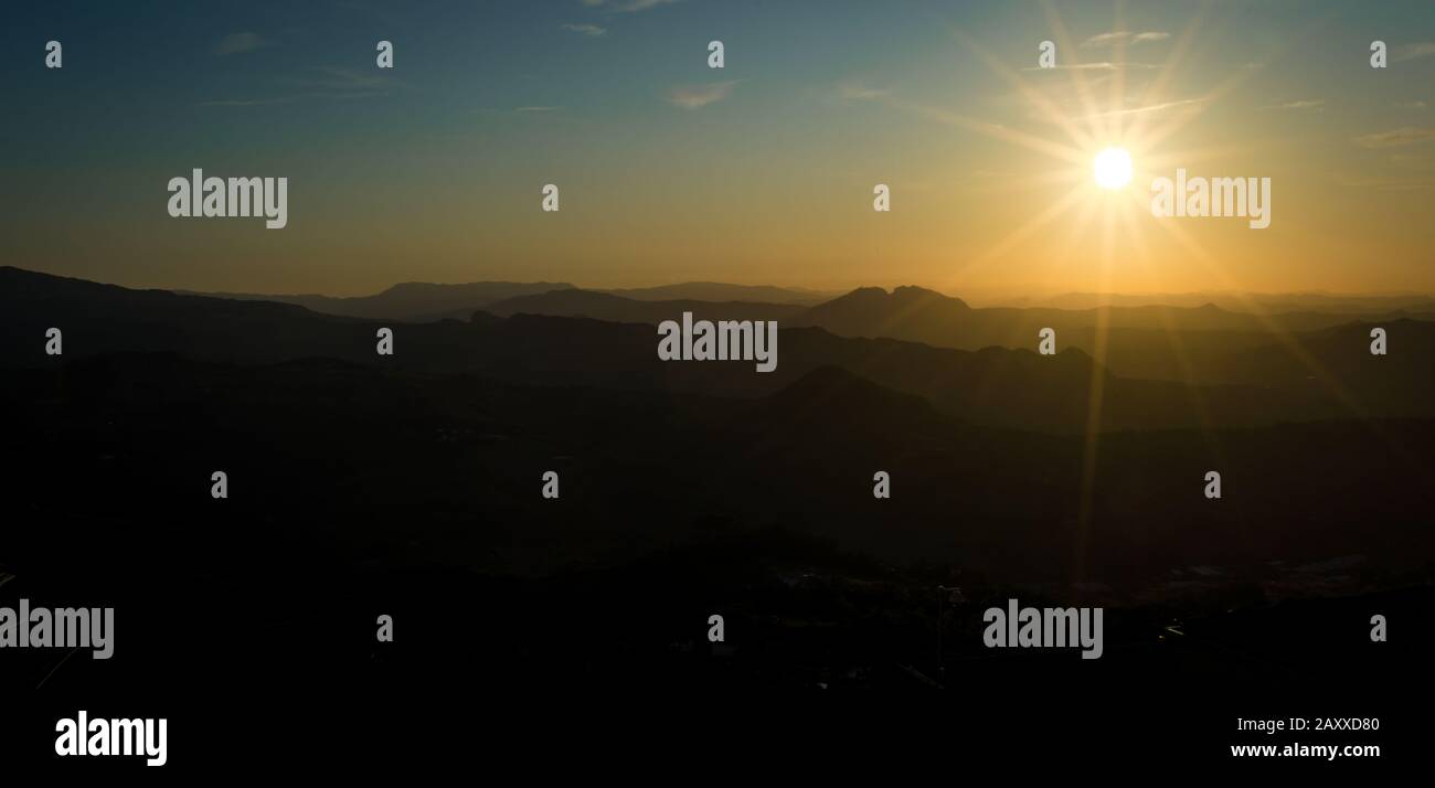 A beautiful sunset over the hills of Italy with sun still above the ...