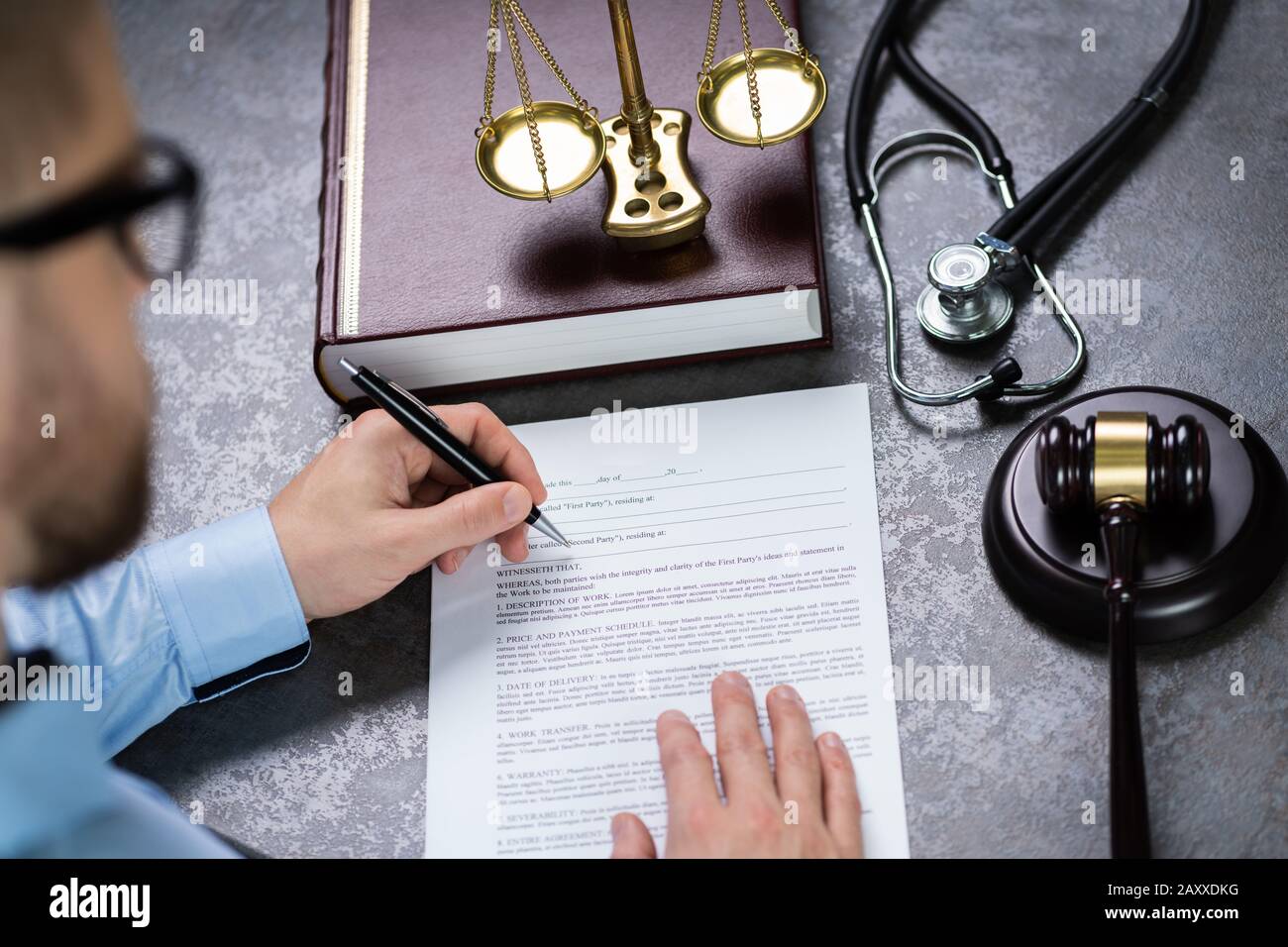 Judge Writing On Document With Mallet And Stethoscope At Desk Stock ...