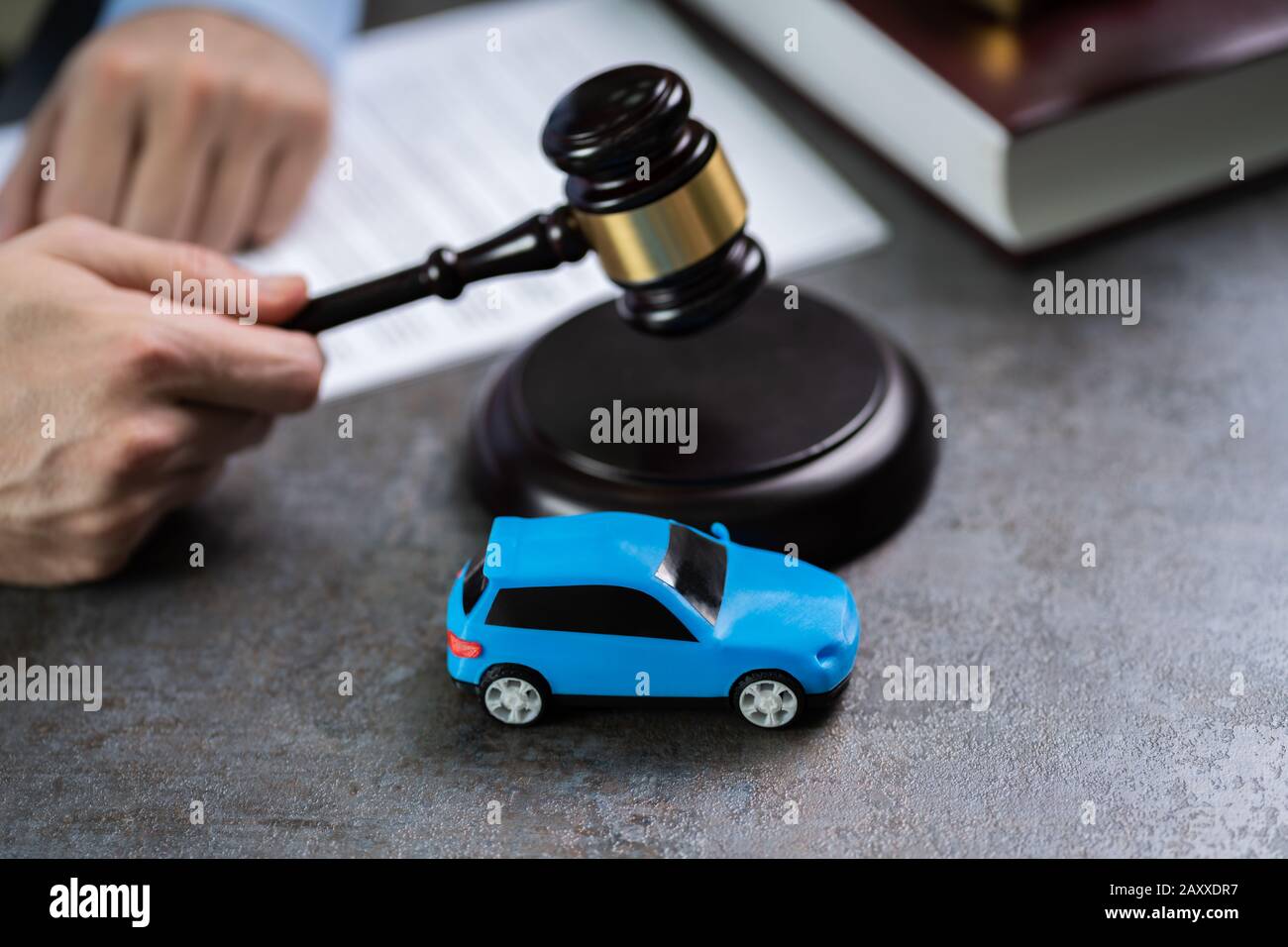 Close-up Of A Small Red Car In Front Of Judge Holding Mallet Stock ...
