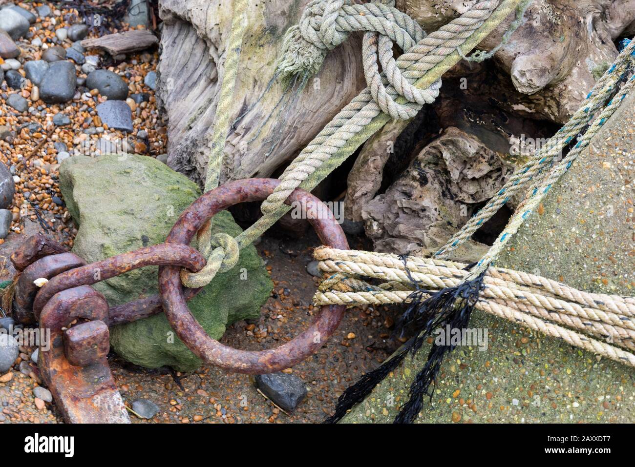 ropes and knots tying boats to a fixture on a dockside or quayside in a ...