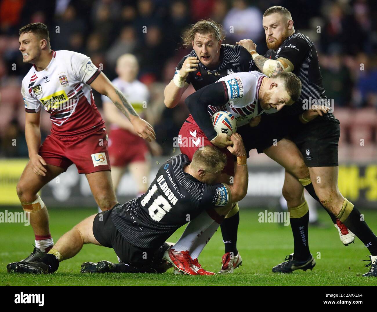 Wigan Warriors' Jackson Hastings is tackled by Toronto Wolfpack's Tom ...