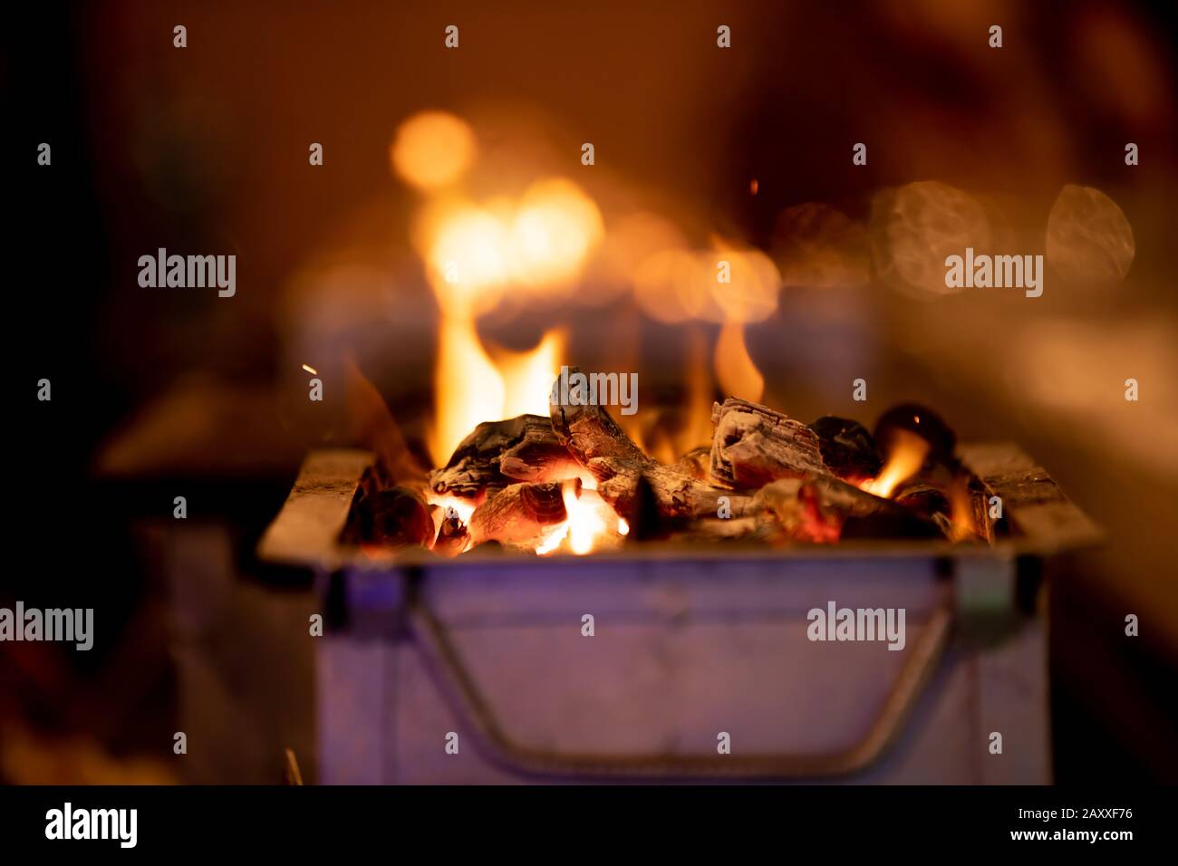 Fire Flames coming from the Coal in Campfire with blur background Stock ...