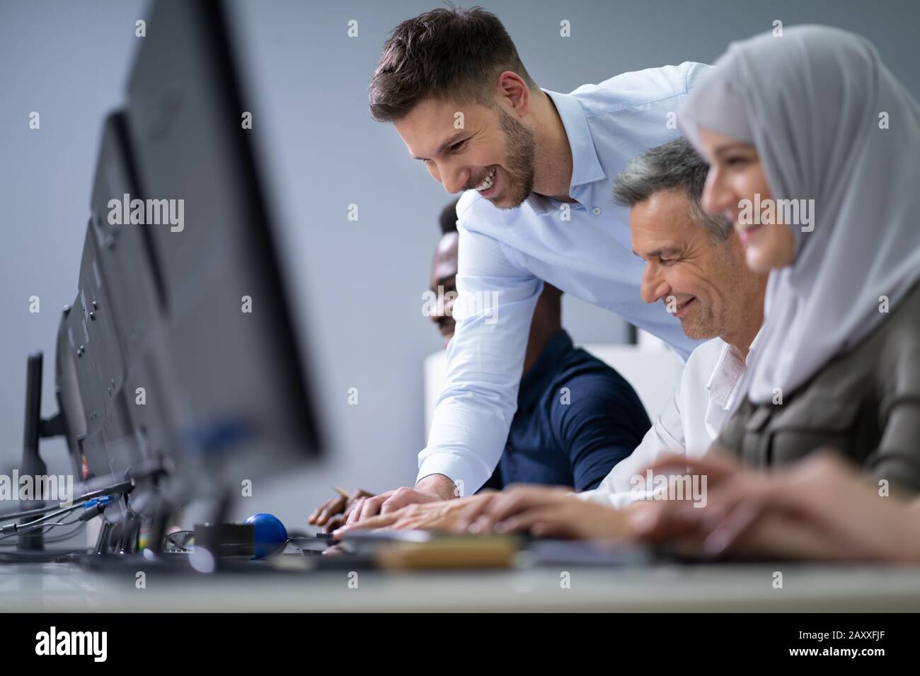 Young Businessman Helping His Colleagues In The Work Of Office Stock ...