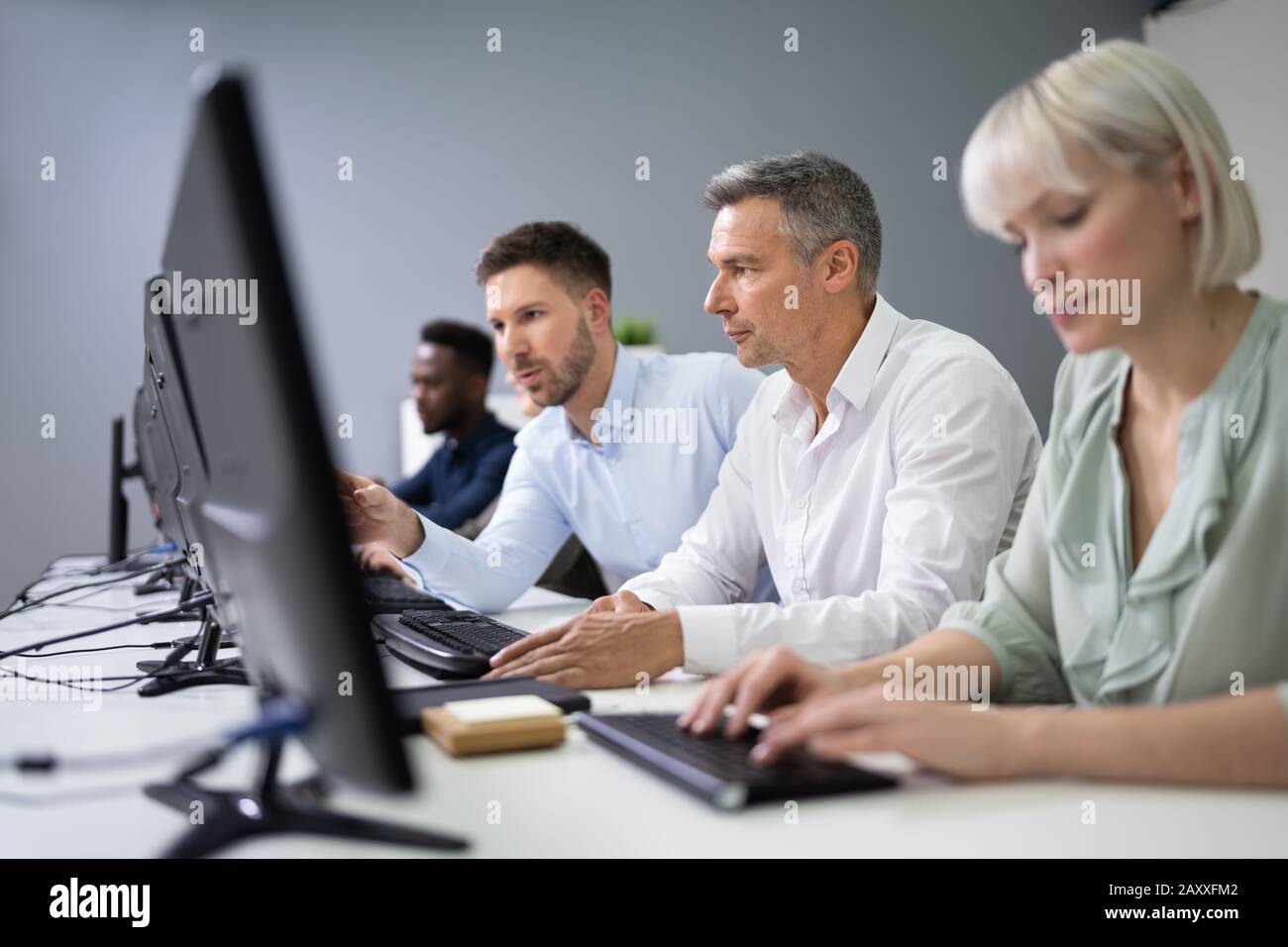 Young Businessman Helping His Colleagues In The Work Of Office Stock ...
