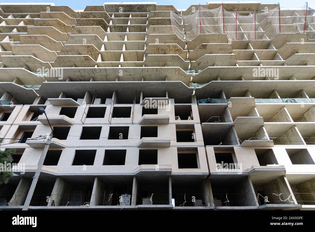 High-rise construction of a new building, decoration of the facades of ...