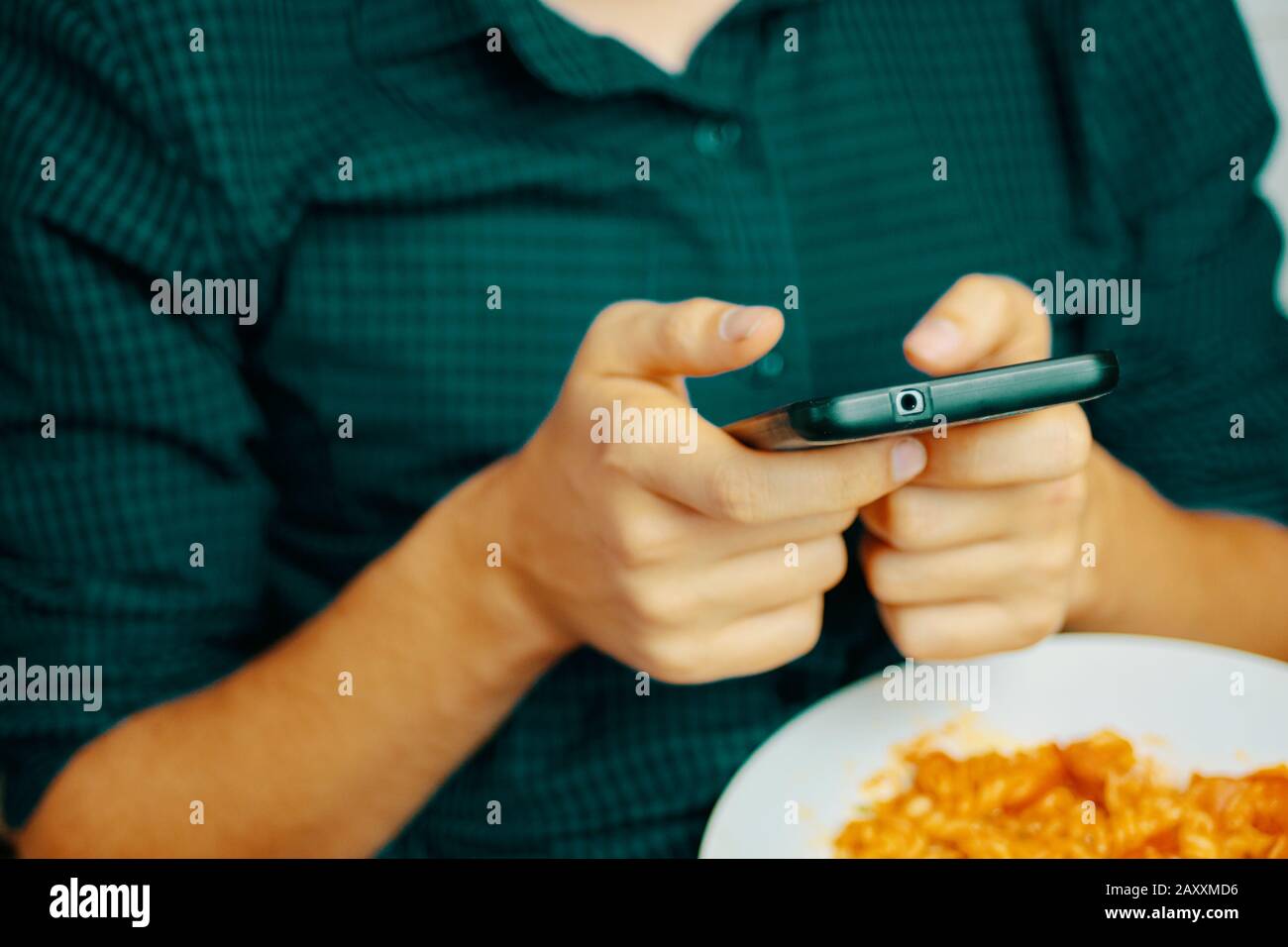 Using smartphone. A young and attractive man uses his phone while ...
