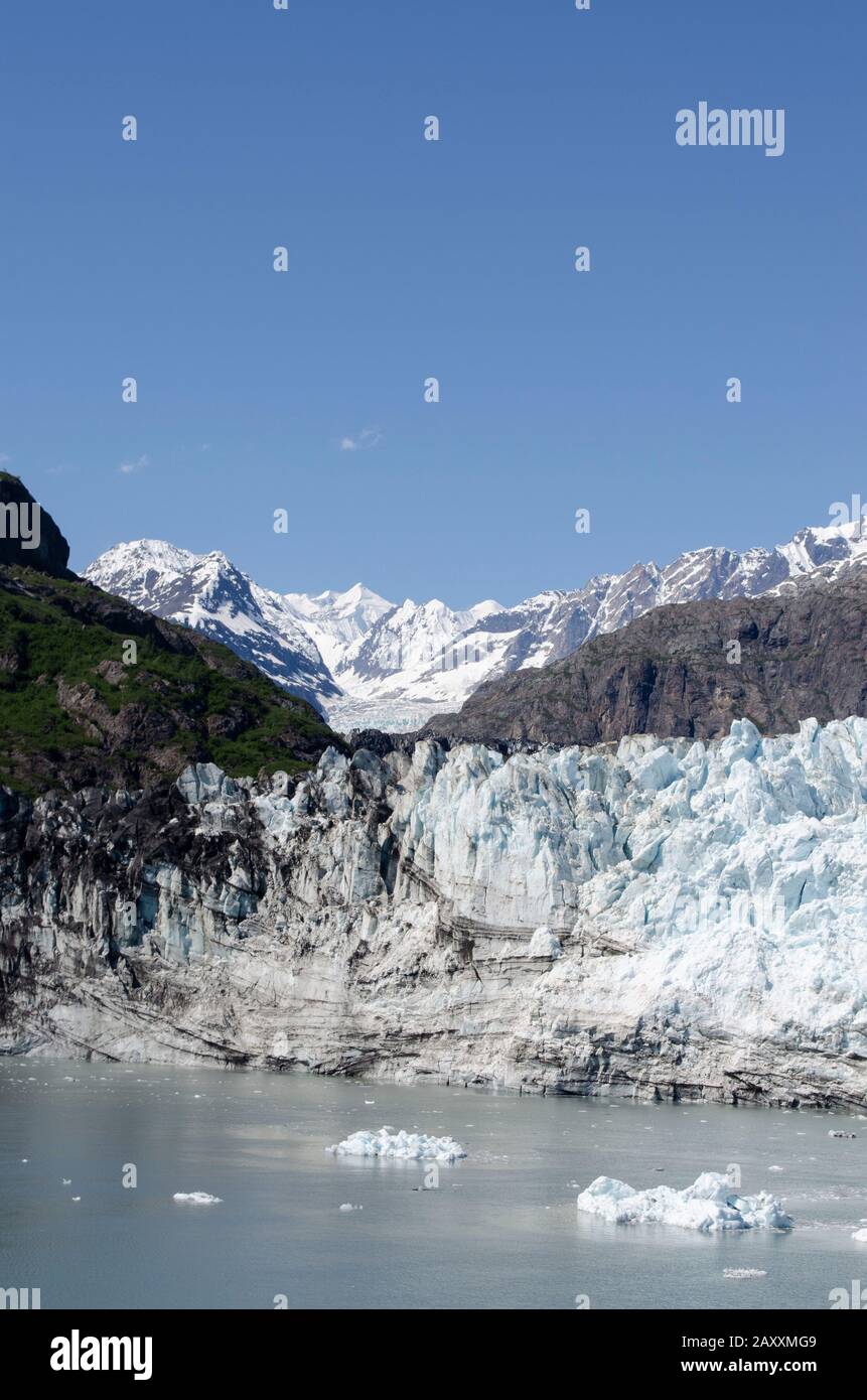 Glacier Bay surrounded by rugged mountains reflected in the calm waters ...