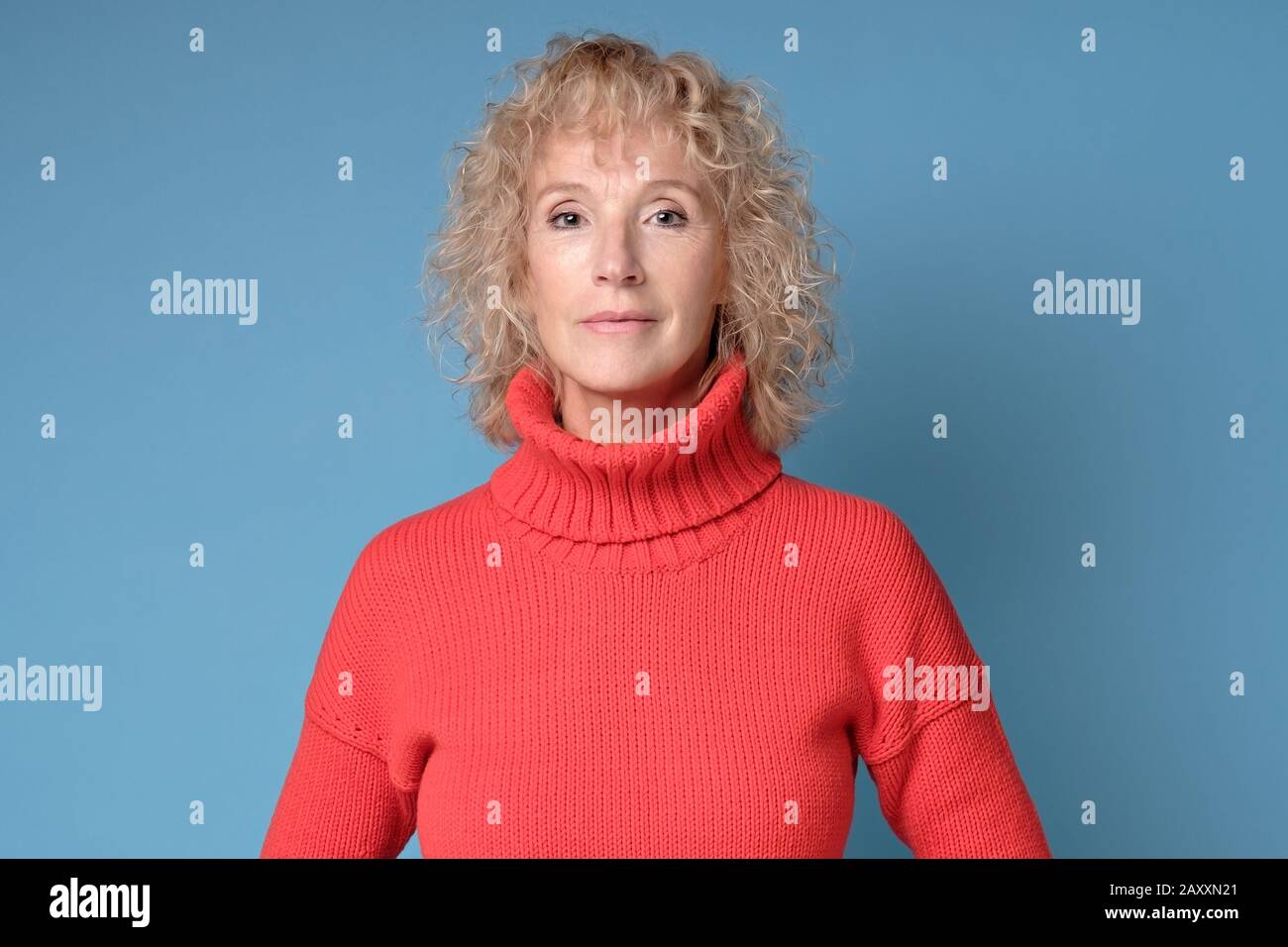 Beautiful elegant elderly lady in red sweater with a lively smile ...