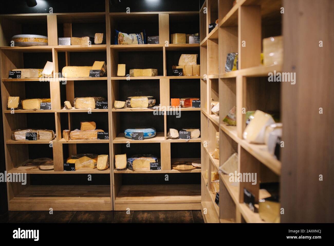 Shelf with cheese in cheese store. Assortment of different cheese types ...