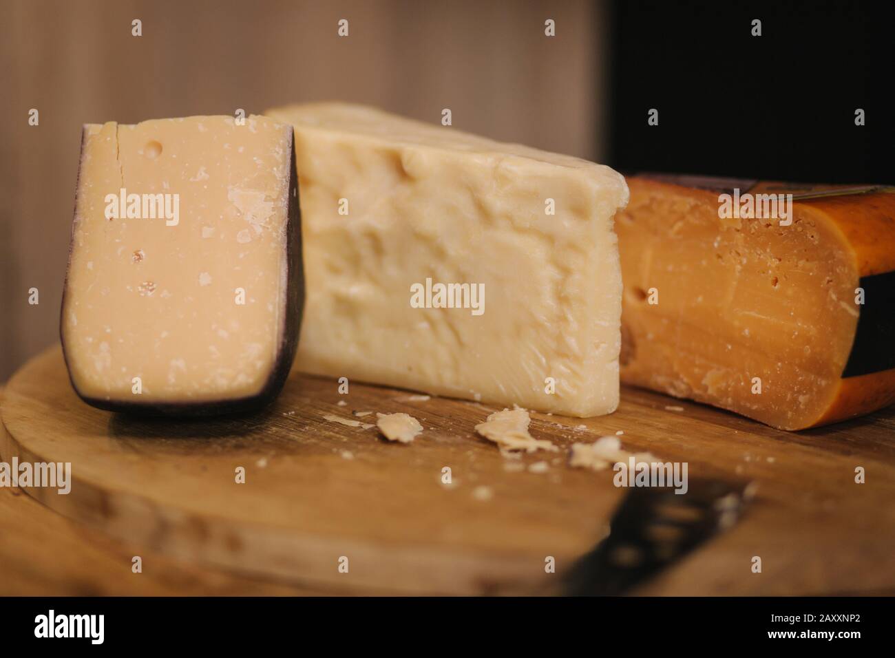 Different types of aged cheese on wooden board Stock Photo - Alamy