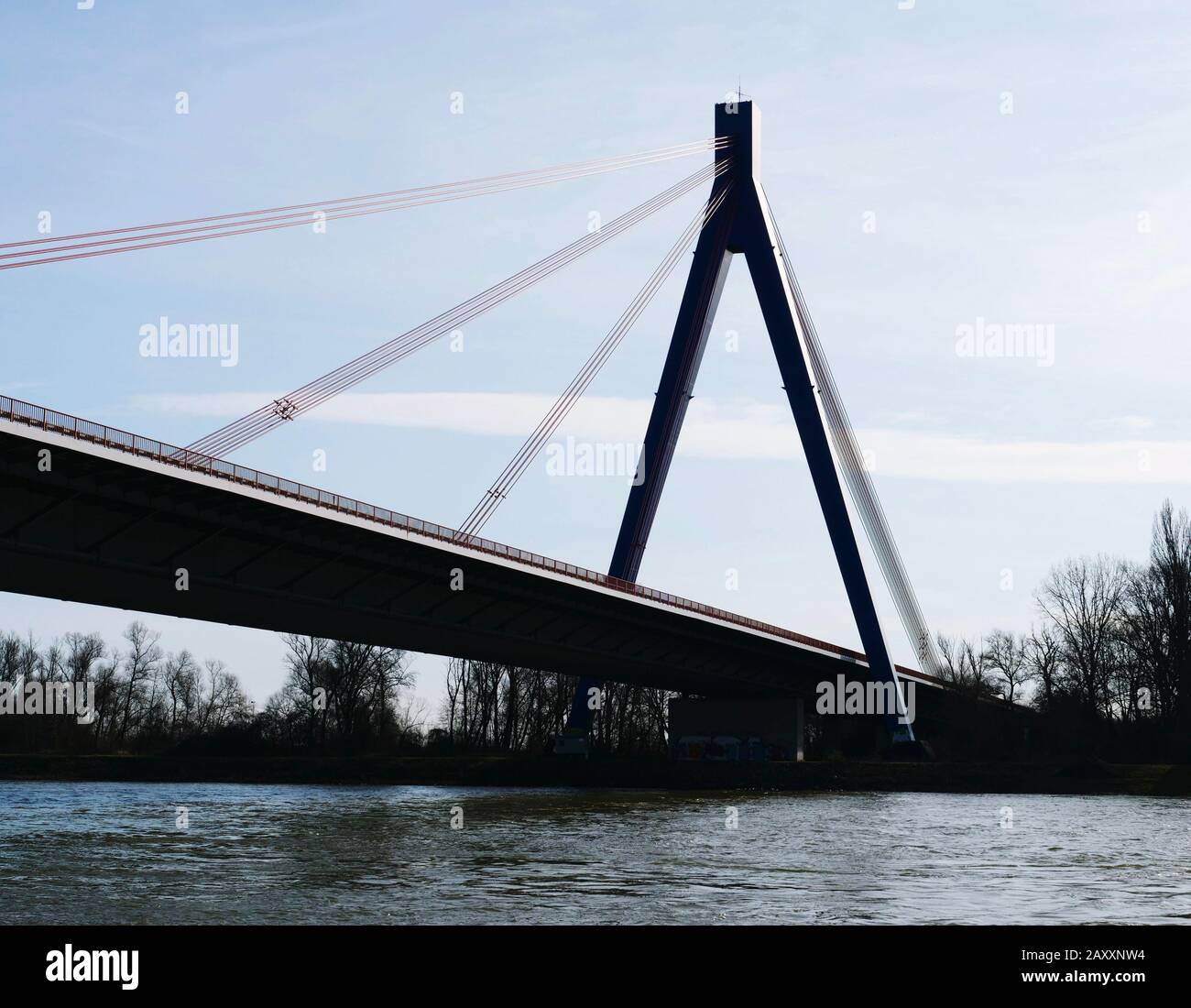 the wide span of a suspension bridge across a river Stock Photo - Alamy