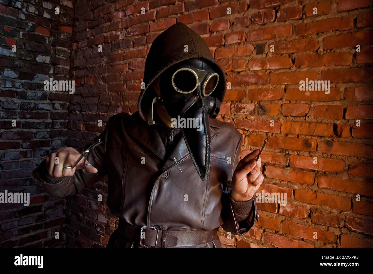 Terrible plague doctor on red brick background. Masked maniac with ...