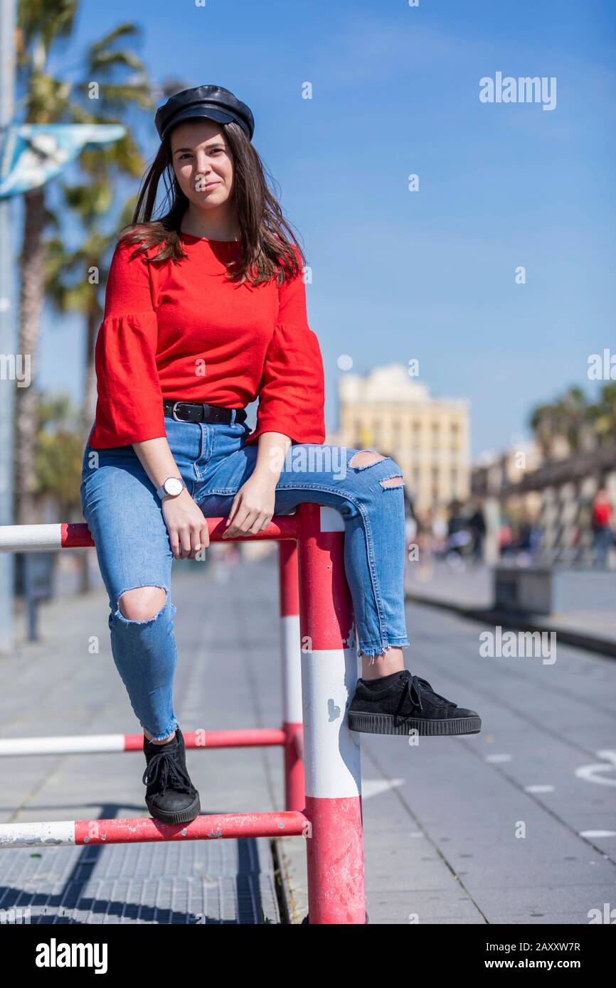 Front view of a smiling beautiful young woman wearing urban clothes ...