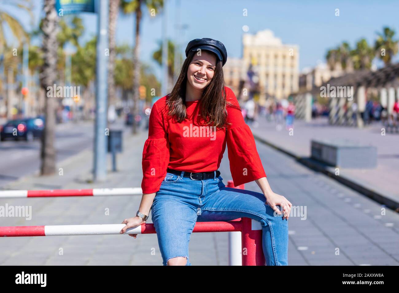 Front view of smiling beautiful young woman wearing urban clothes ...