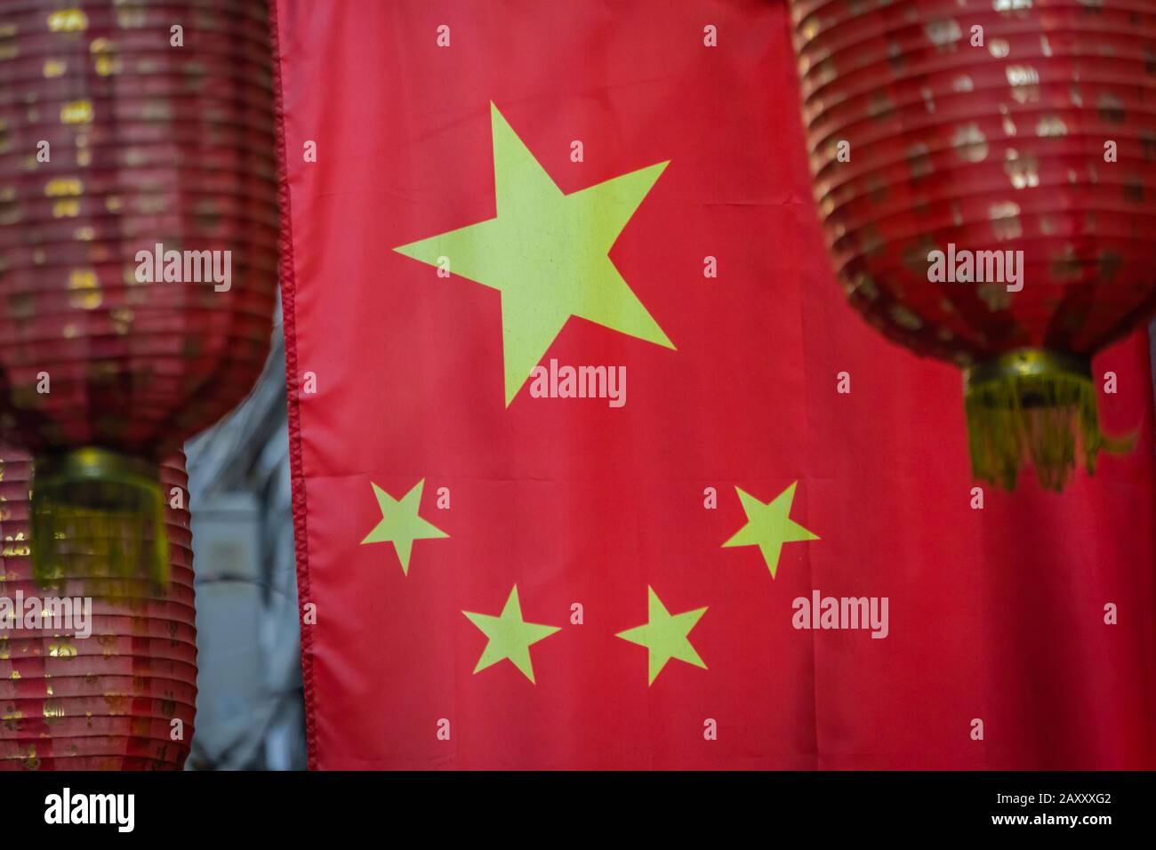 Chinese flag flutering above narrow street in the Old town of Fenghuang ...