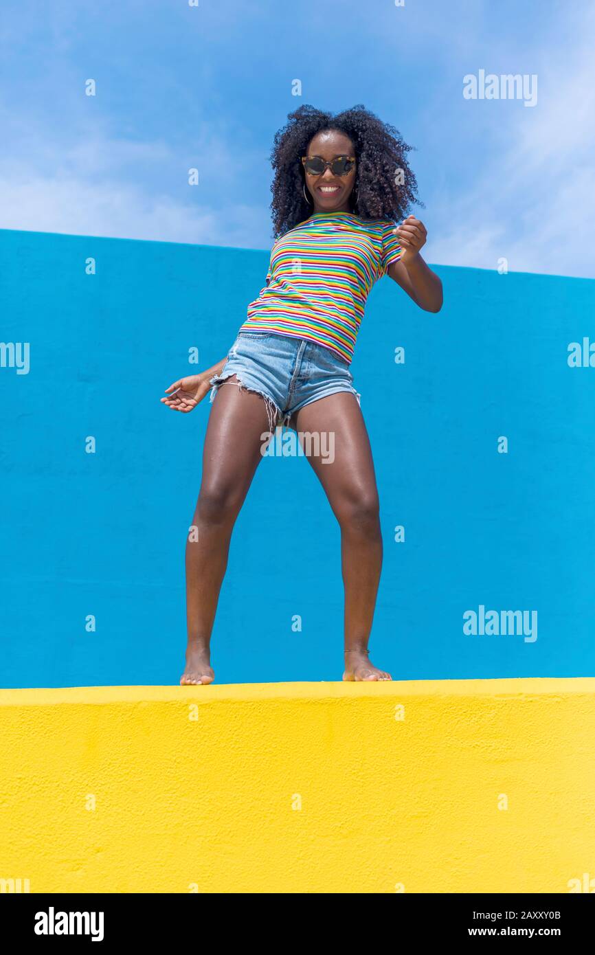 Mixed race smiling black woman portrait with big afro curly hair ...