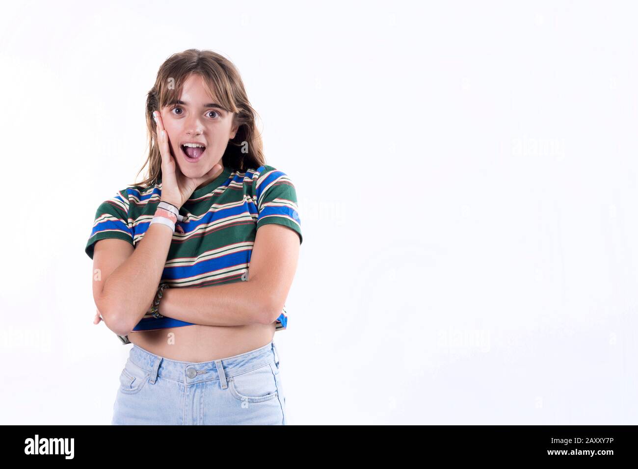Surprised young female student over white background Stock Photo - Alamy