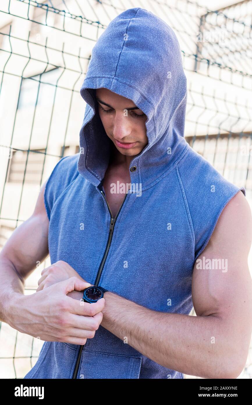 Athlete checking his smartwatch in the city Stock Photo - Alamy