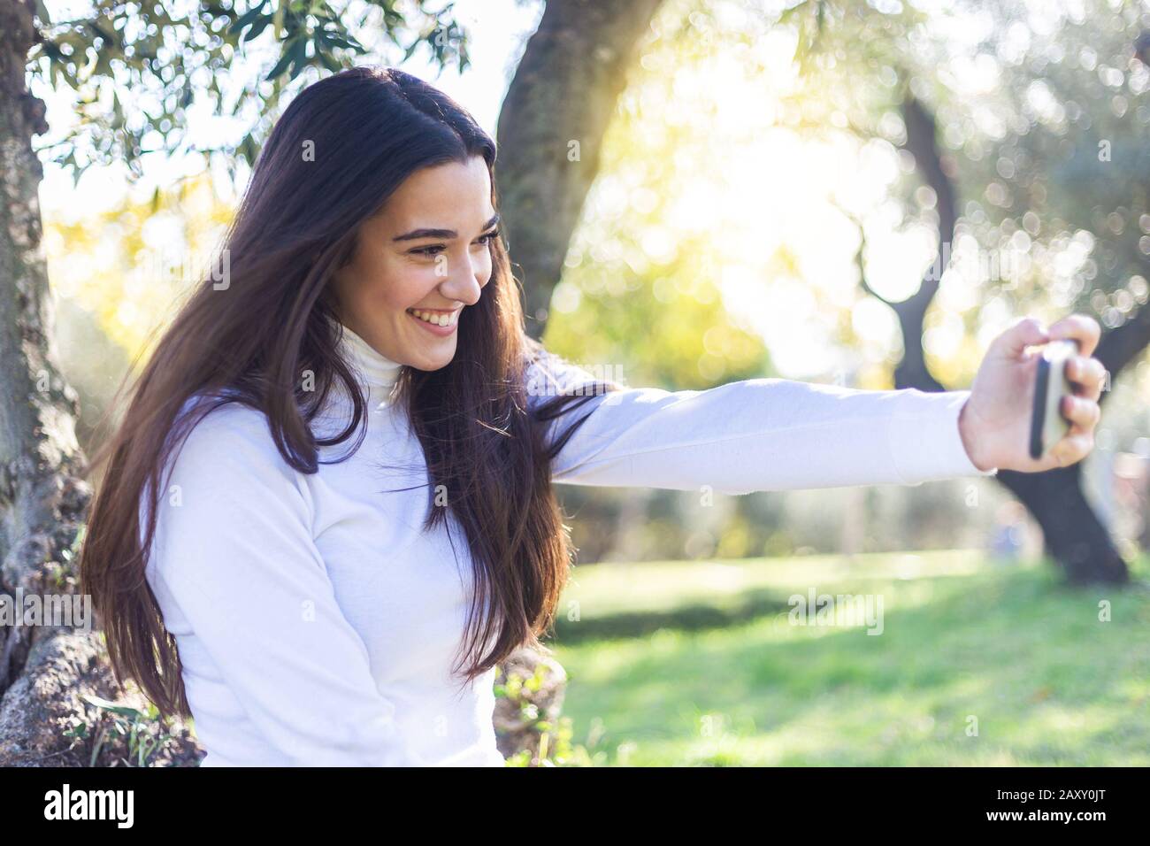 Beautiful young woman taking a self portrait Stock Photo - Alamy