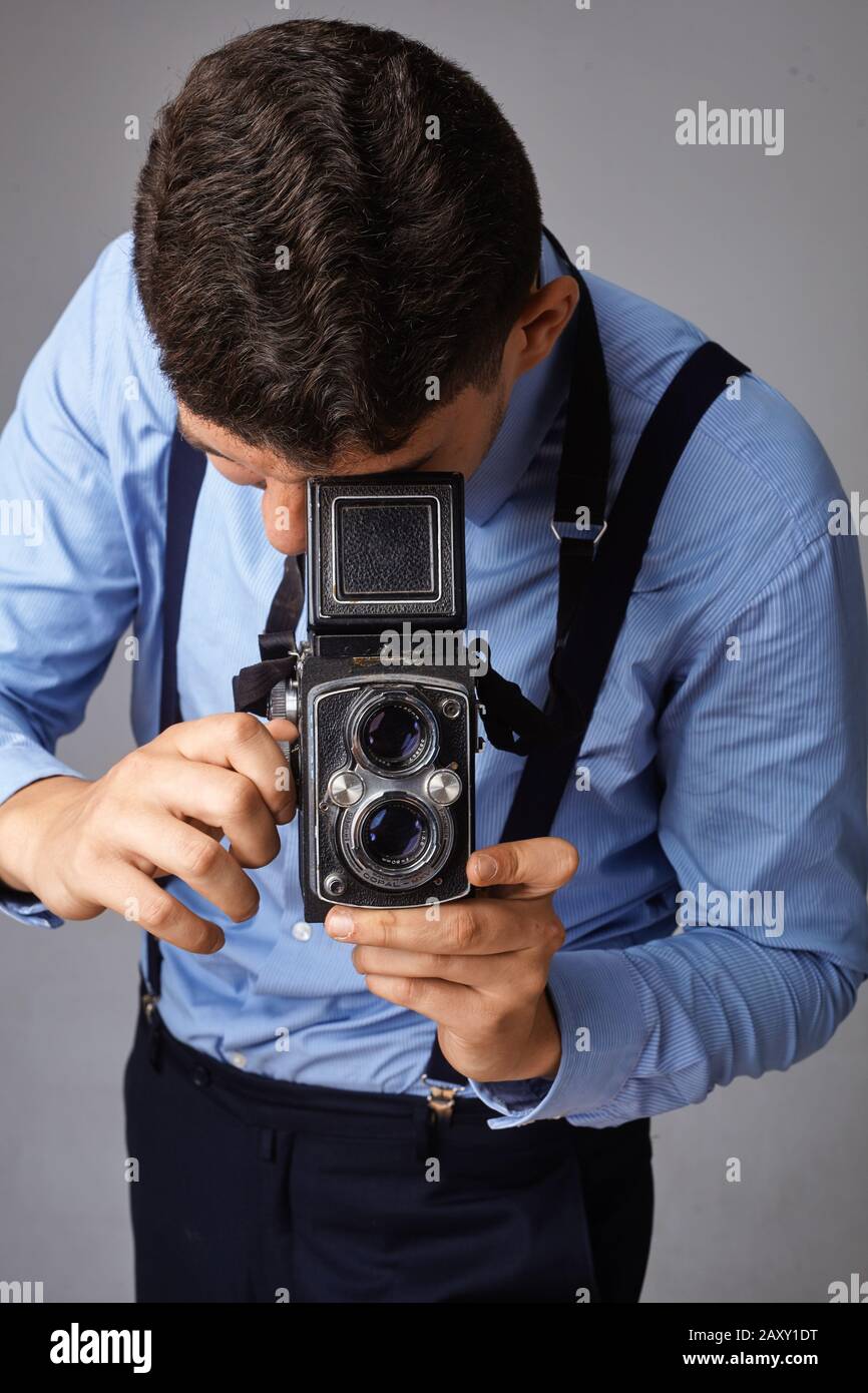 guy with the old camera at the studio. Guy shoots on an old vintage ...