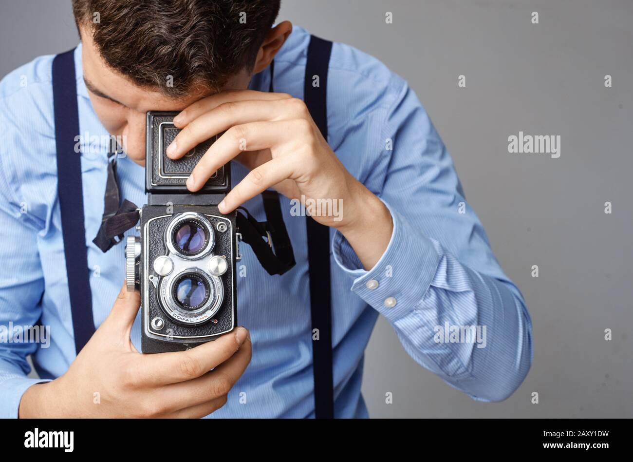 guy with the old camera at the studio. Guy shoots on an old vintage ...