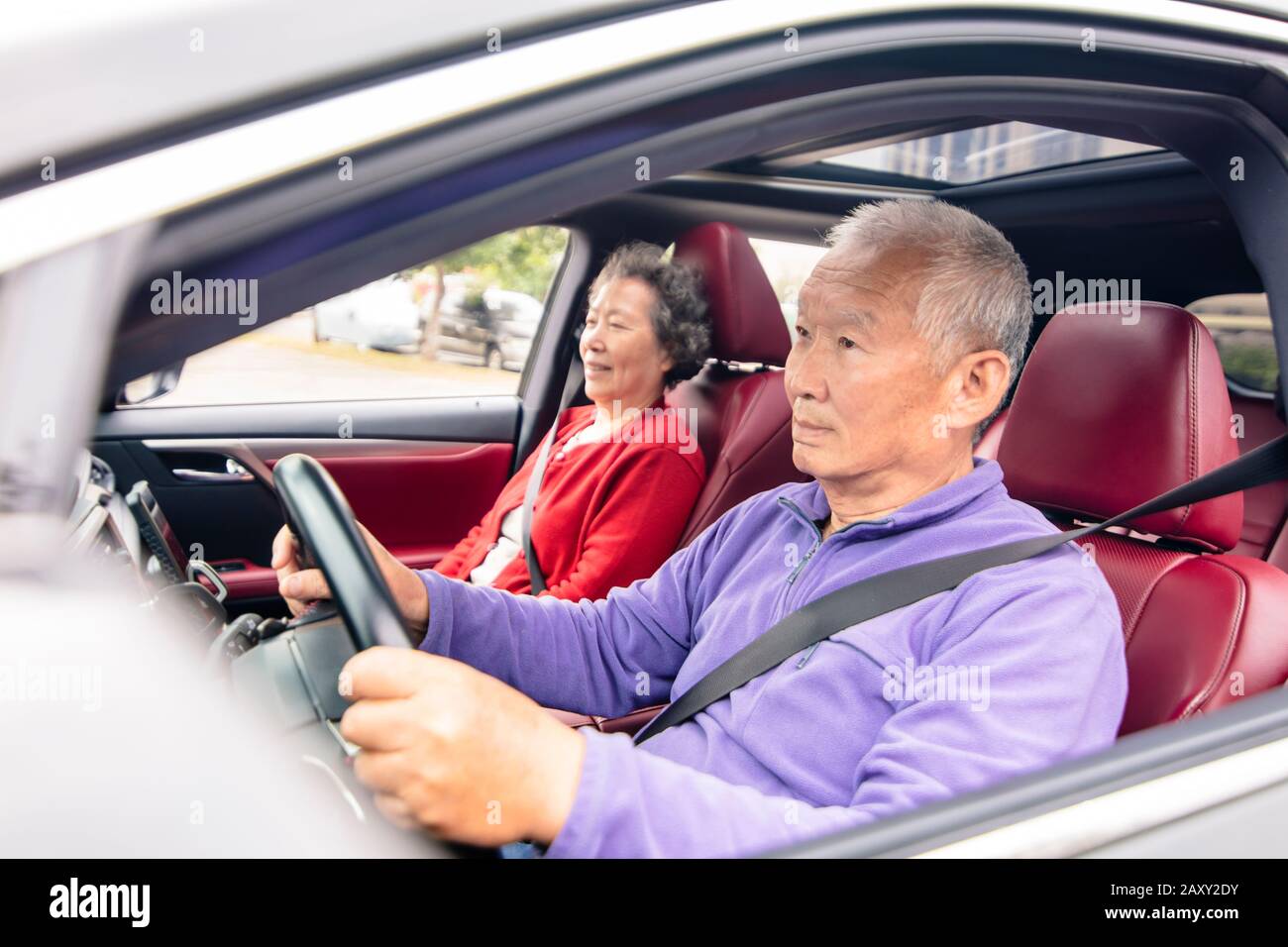Happy asian senior couple driving car Stock Photo - Alamy