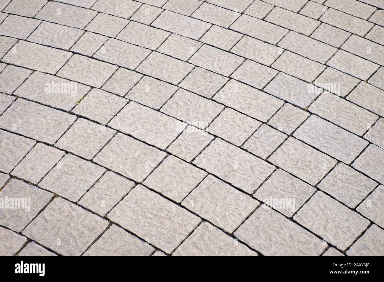 Curved patterns formed with gray cobble stones, modern pavement finish ...