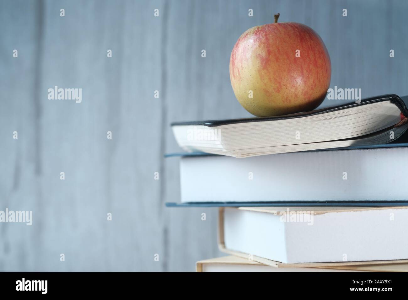 apple on stack of books , back to school concept Stock Photo - Alamy