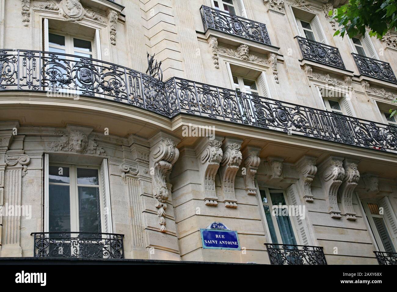 Paris, typical old apartment building with ornate baroque stonework ...