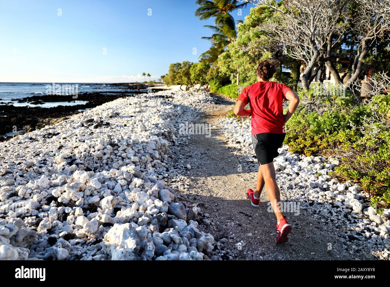 Man running on beach hawaii hi-res stock photography and images - Alamy