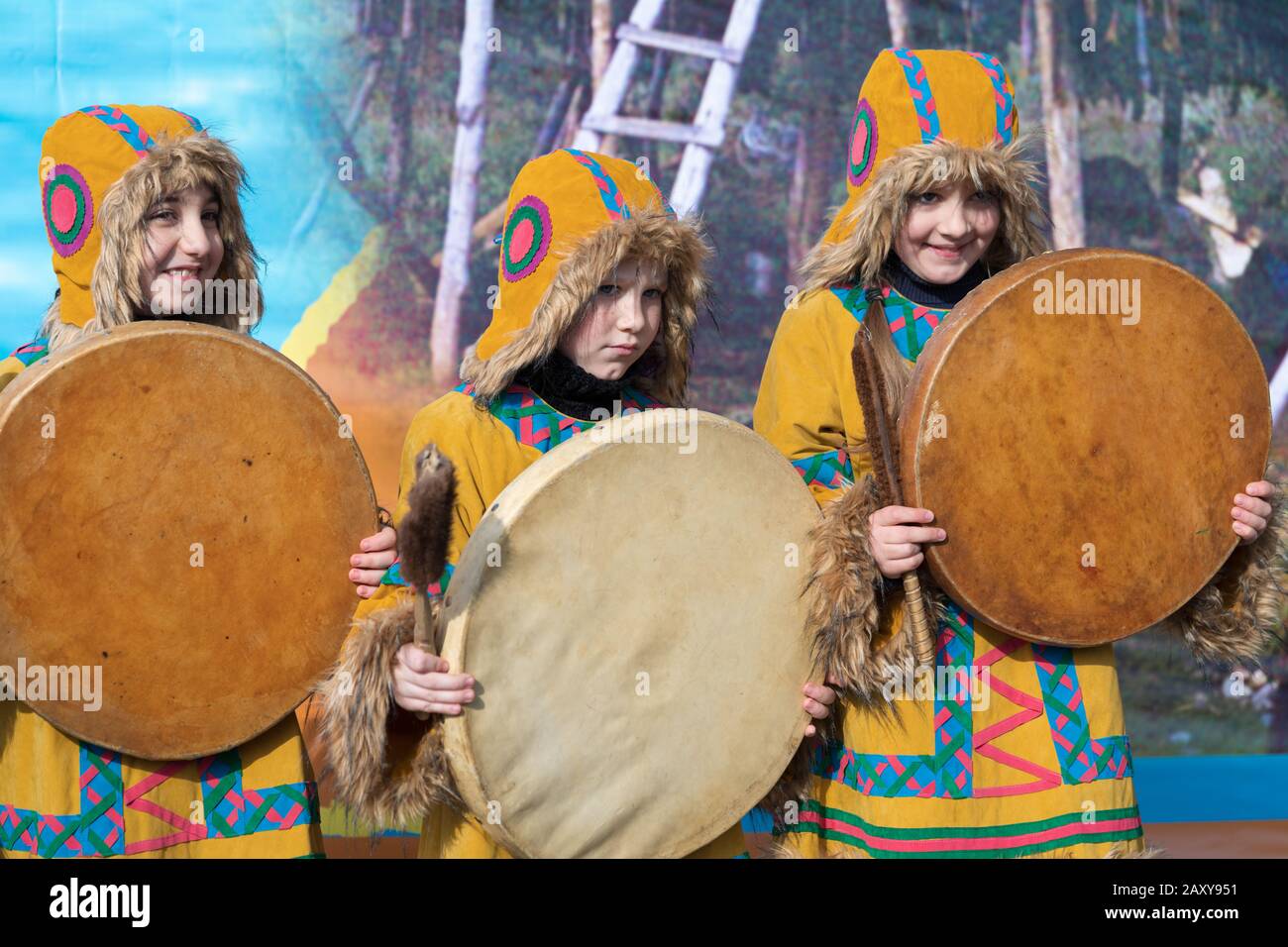 Girls dancing with tambourine in national clothing indigenous ...