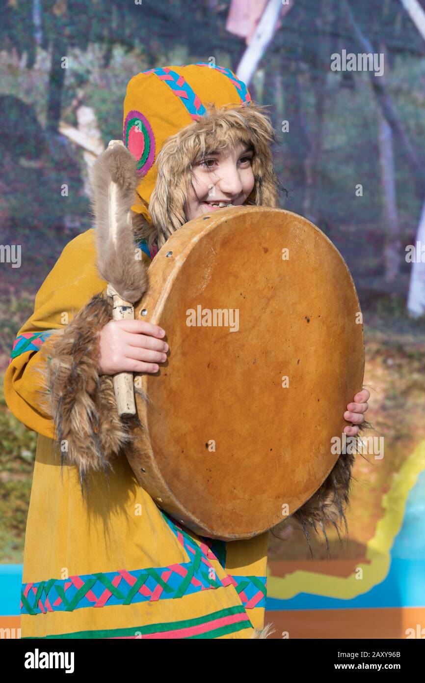 Female child dancing with tambourine in national clothing indigenous ...