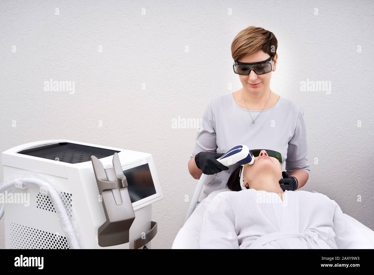 Young woman receiving laser treatment Stock Photo - Alamy