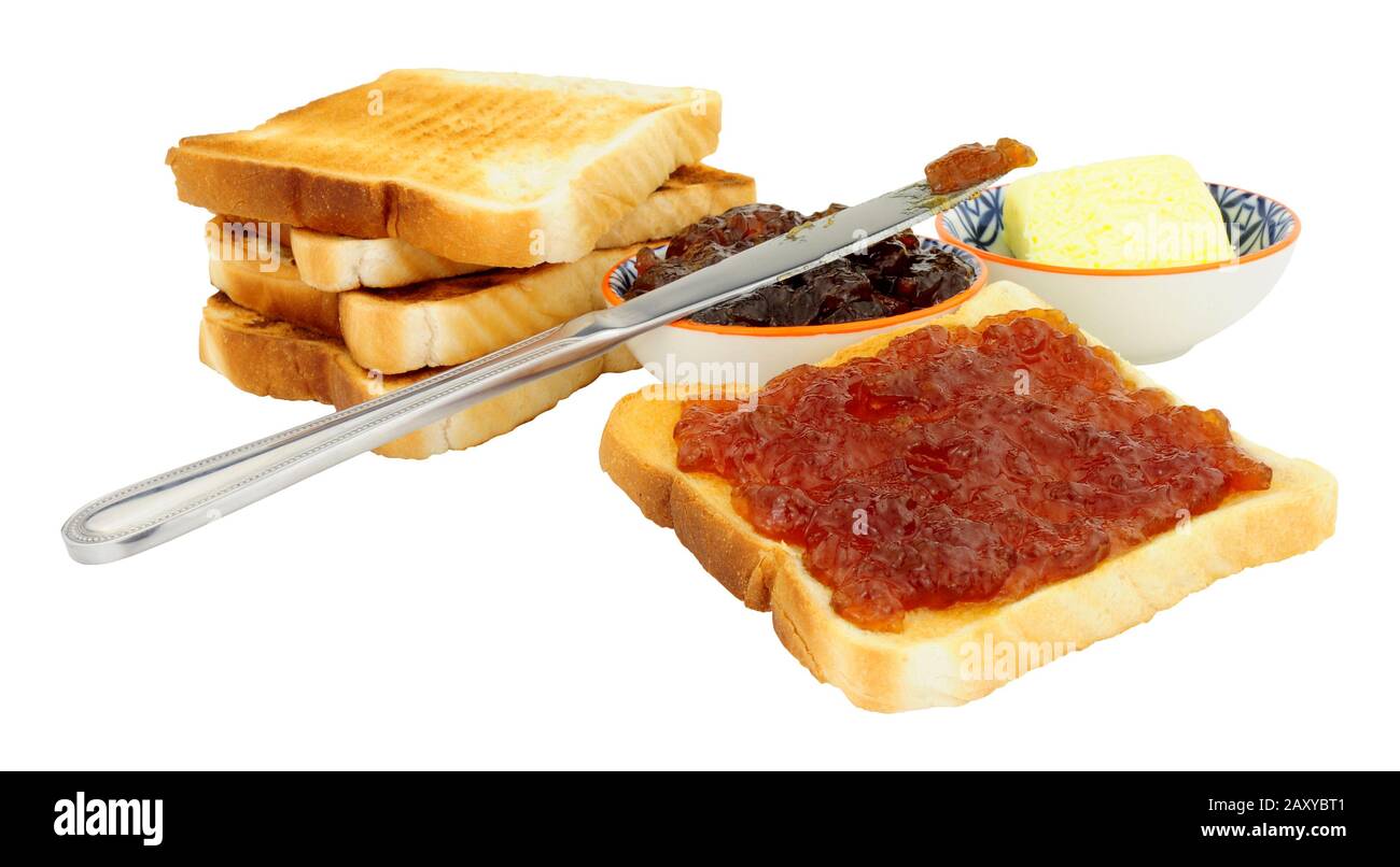 Orange fruit marmalade spread on toast isolated on a white background ...