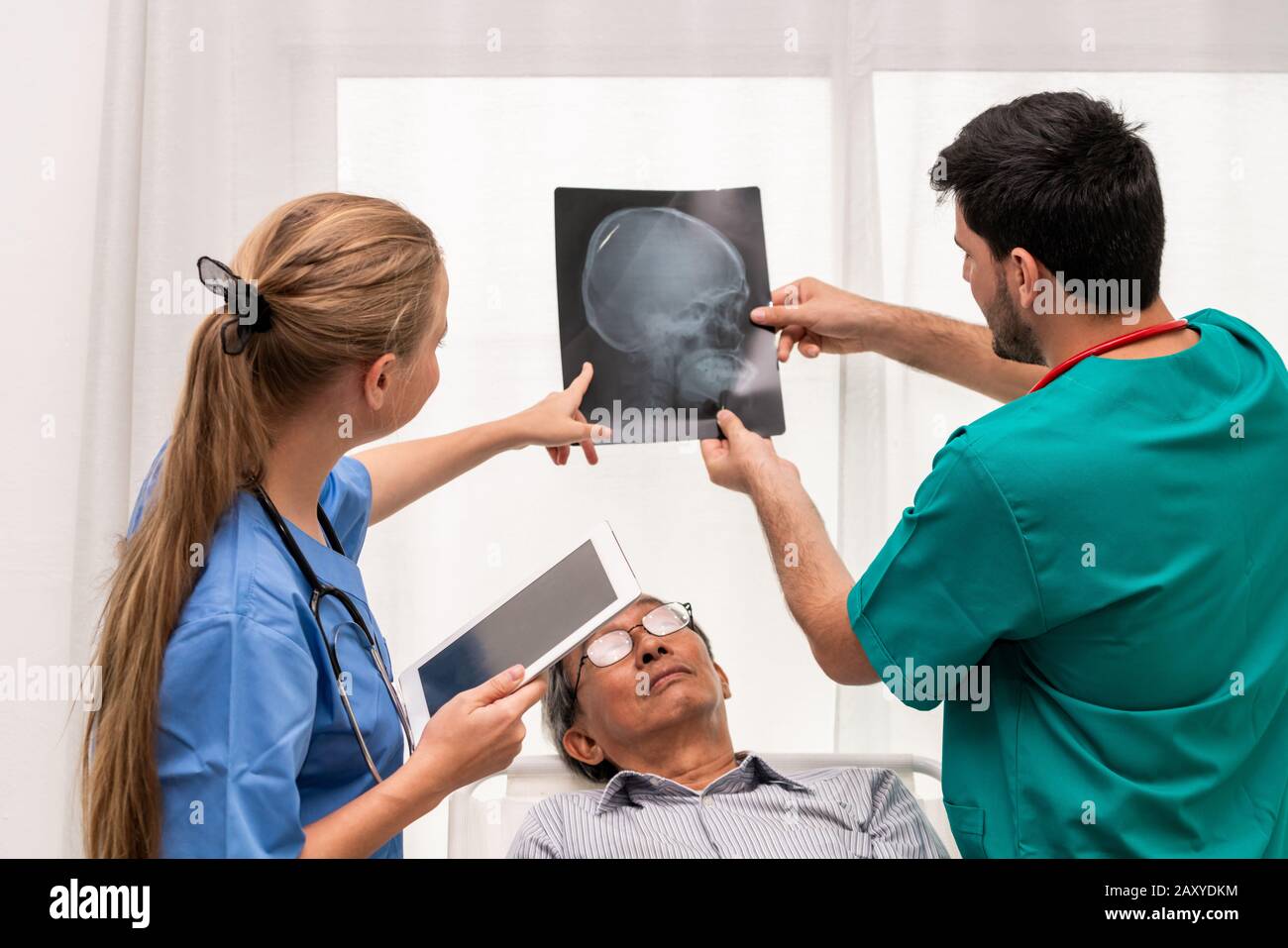Doctor team work with x ray film image of the senior adult patient ...