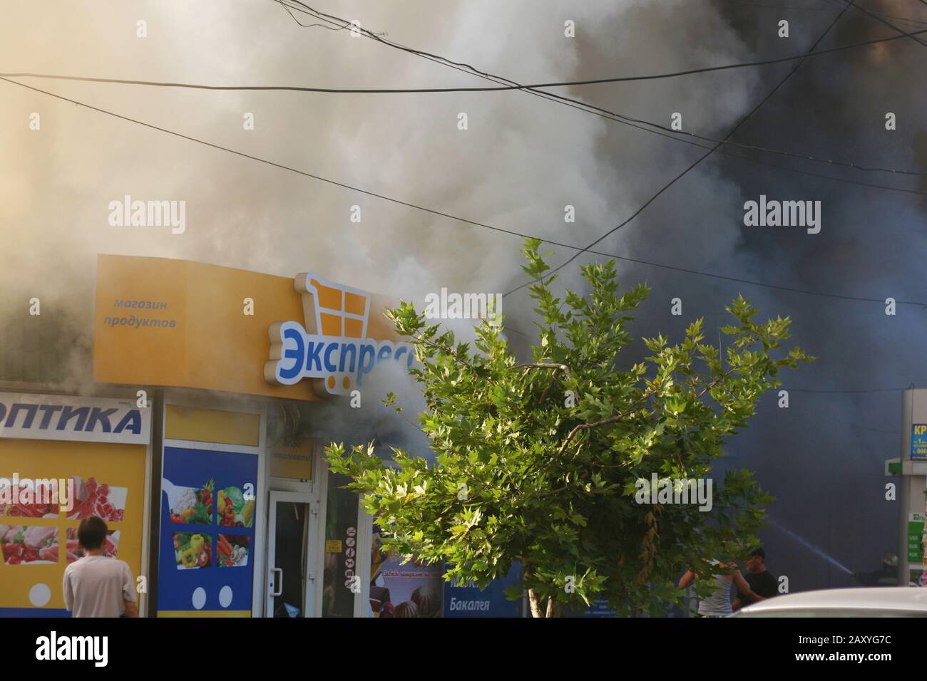 Burning building in the city. Fire extinguishing operation Stock Photo ...