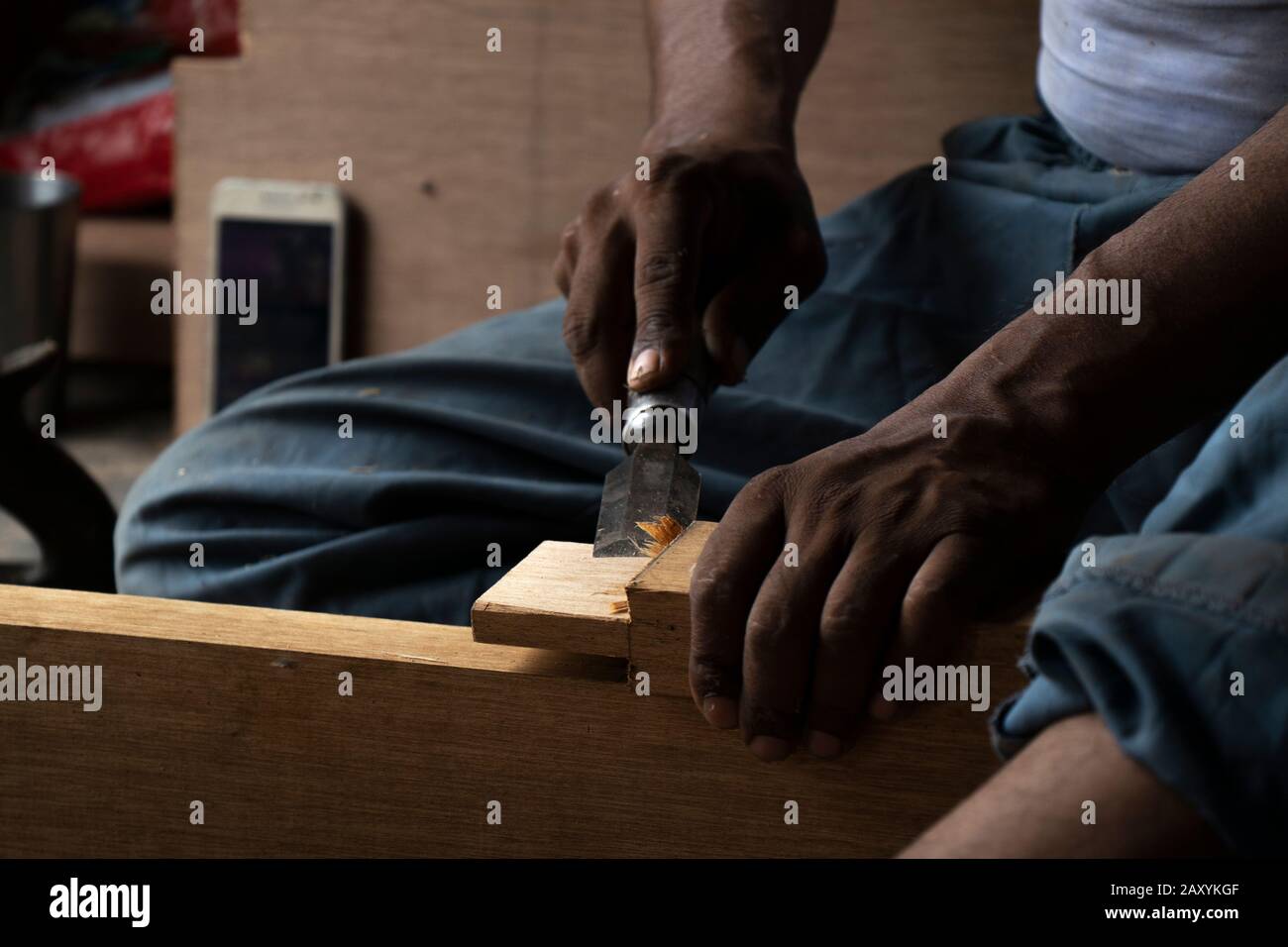Carpenter working with gouge on table in his workshop Stock Photo - Alamy