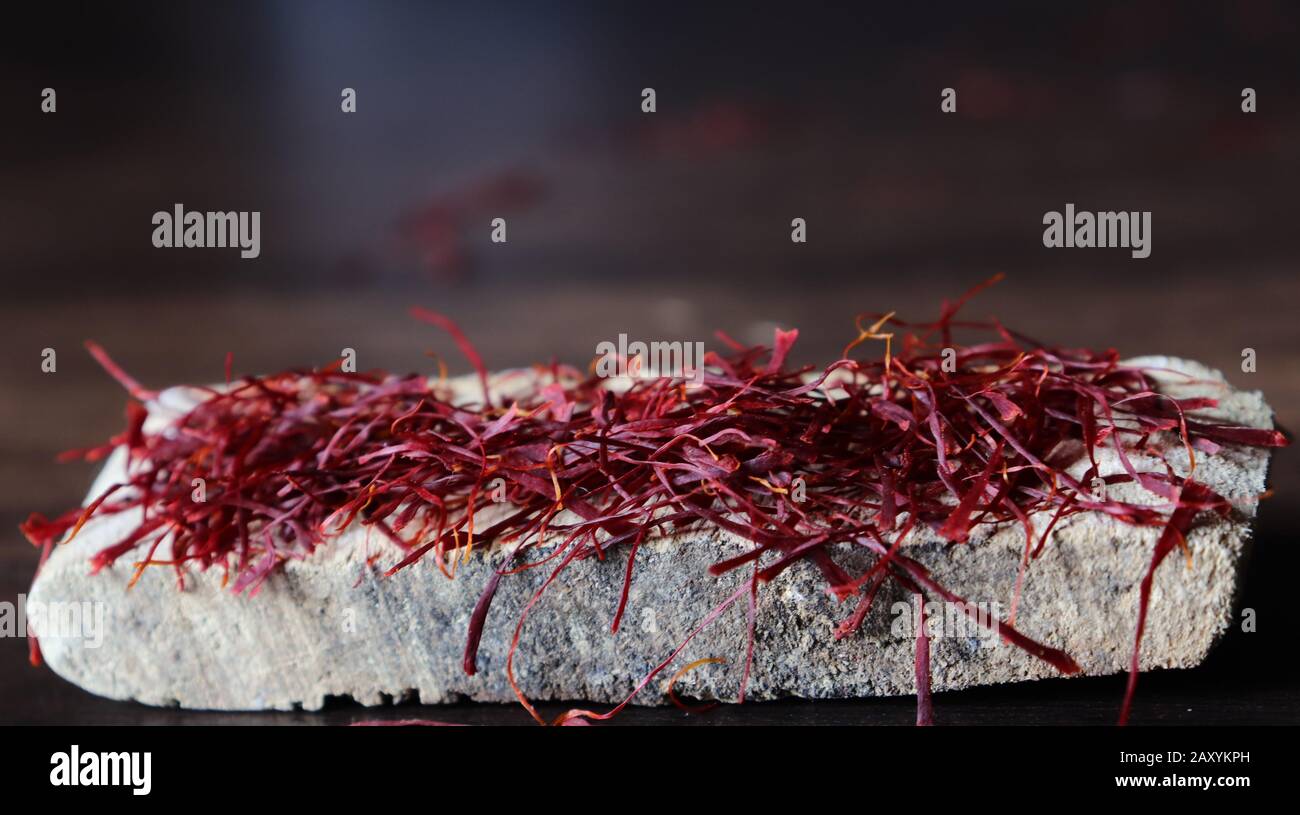 Kashmiri Saffron crocus/threads/kesar on a block of wood/Still life ...