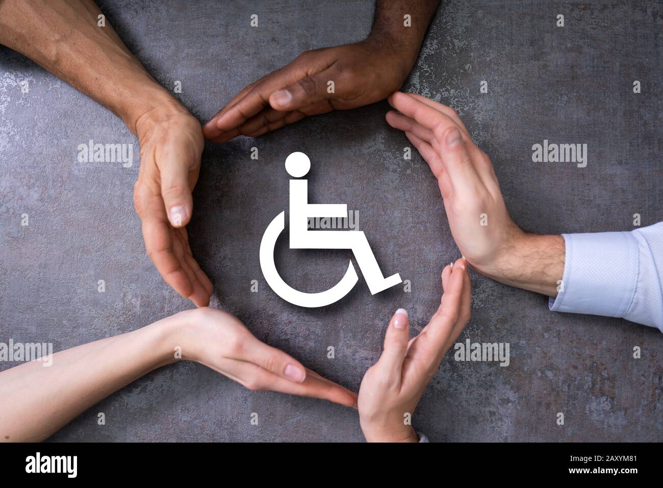 Close-up Of A Hands Protecting Disabled Handicap Icon Stock Photo - Alamy