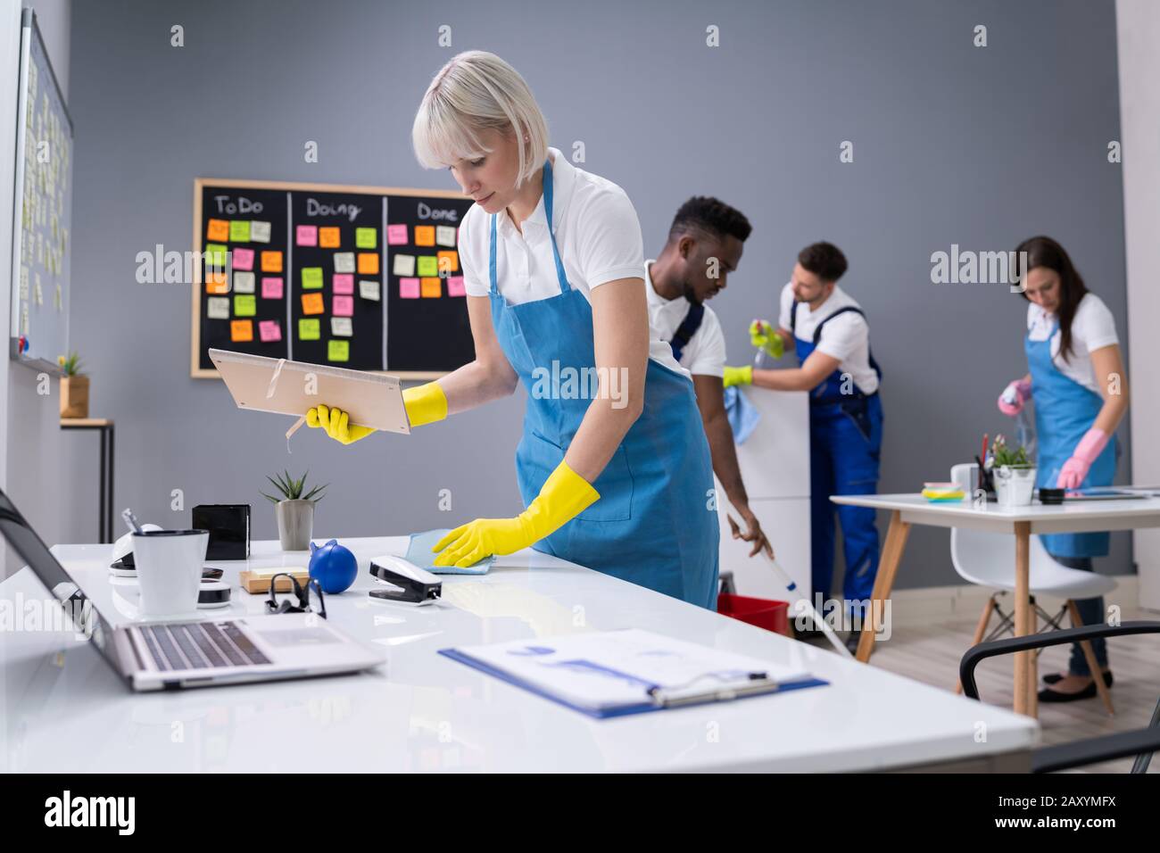 Group Of Janitors In Uniform Cleaning The Office With Cleaning ...