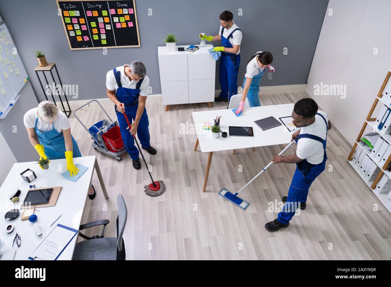 Group Of Janitors In Uniform Cleaning The Office With Cleaning ...
